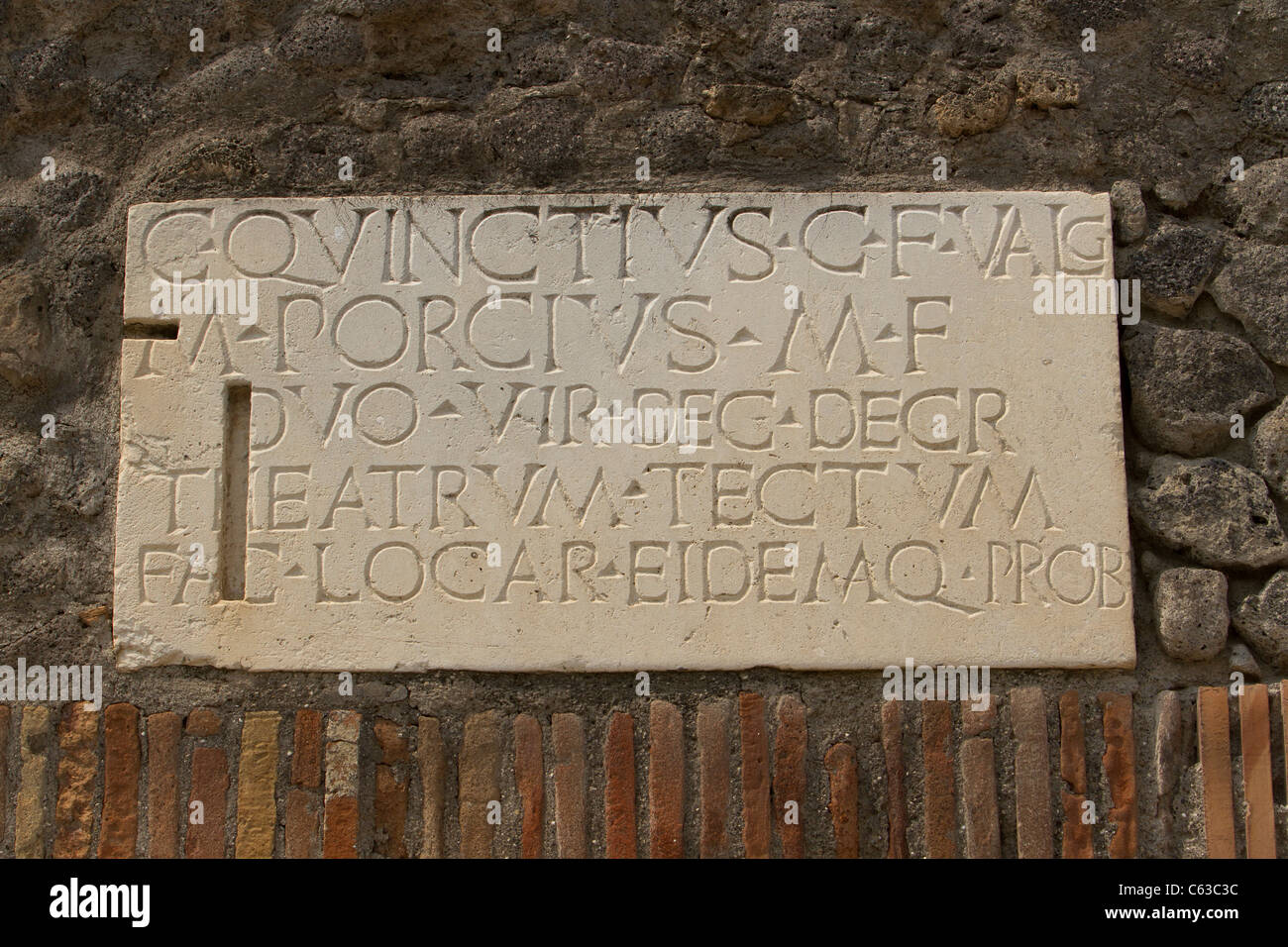 Pompeii ruins engraving and carved stone sign on wall of ruins Stock ...