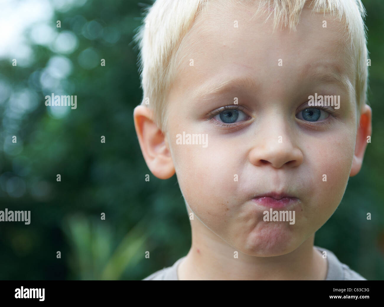 Young Blond Boy Making a emotion funny Face - portrait Stock Photo - Alamy