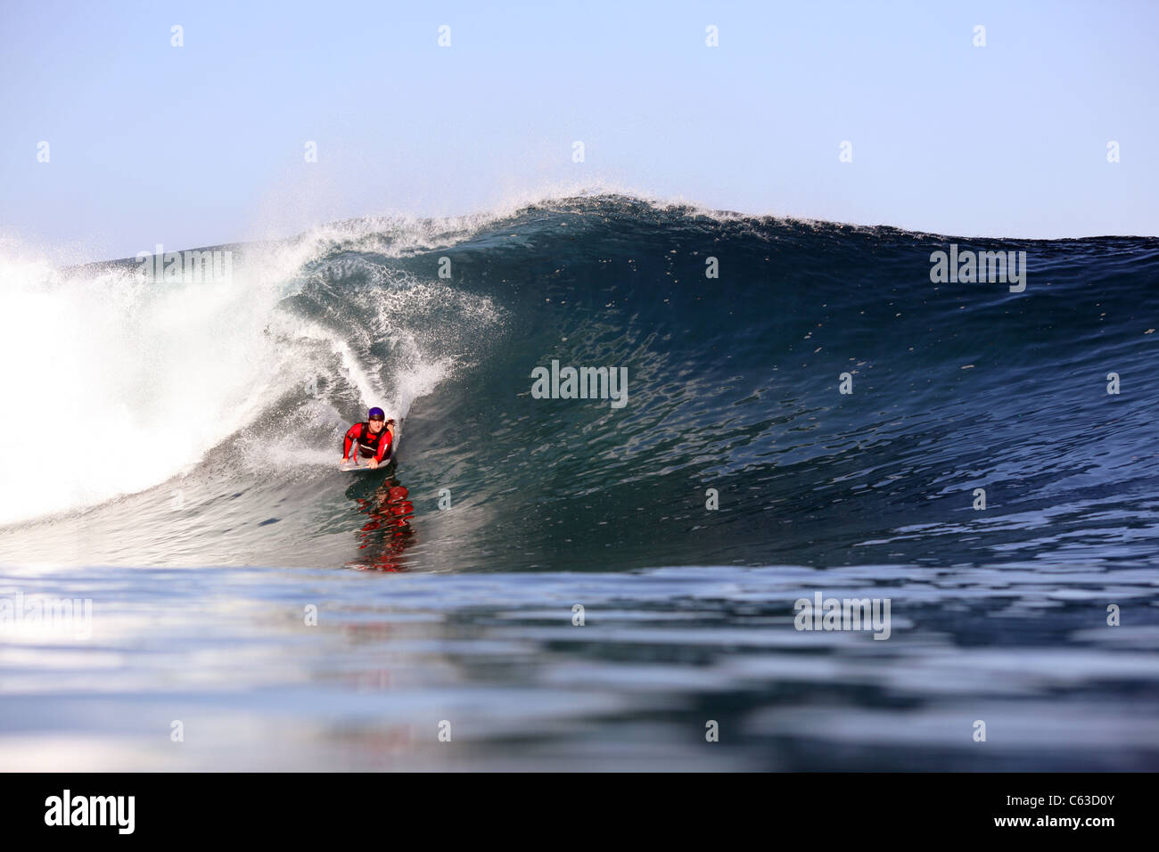 Body boarder surfing a wave at Scar Reef in Sumbawa, Indonesia Stock ...