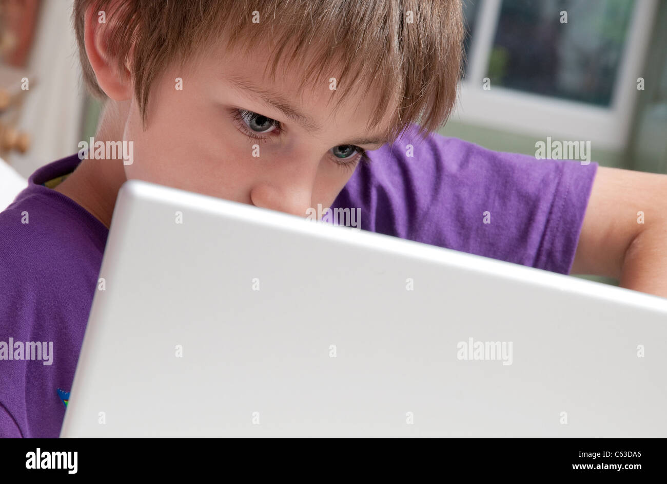 young male boy using his laptop computer Stock Photo - Alamy