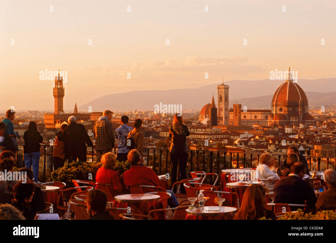 People and tables at outdoor cafe at Piazzale Michelangelo above Arno ...