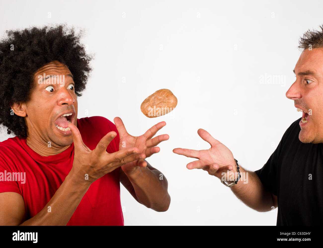 Passing on the hot potato, a concept Stock Photo - Alamy