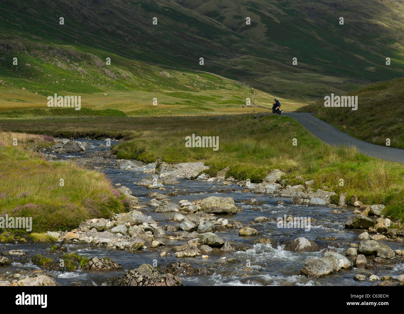 Scooter rider stopping next to the River Duddon, at Cockley Beck, Lake ...