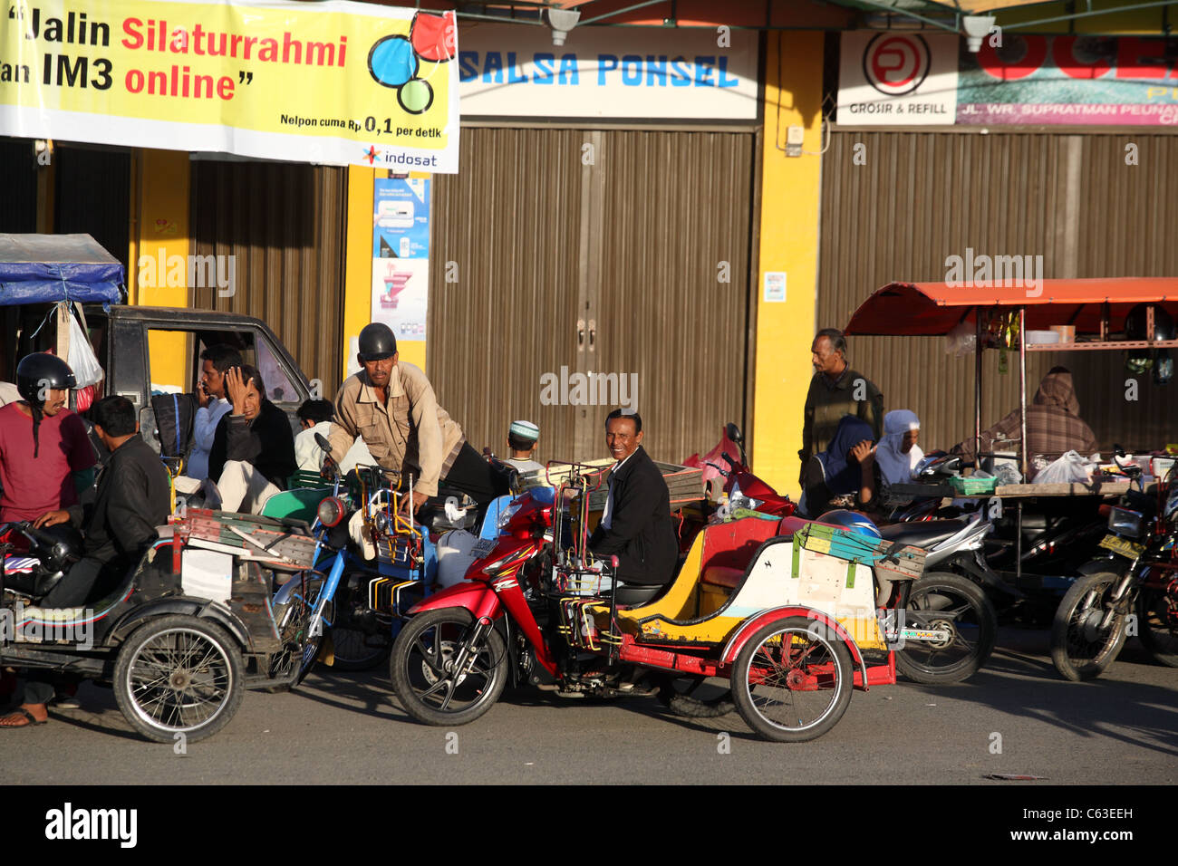 Motor taxi drivers waiting for the afternoon rush in the city center ...