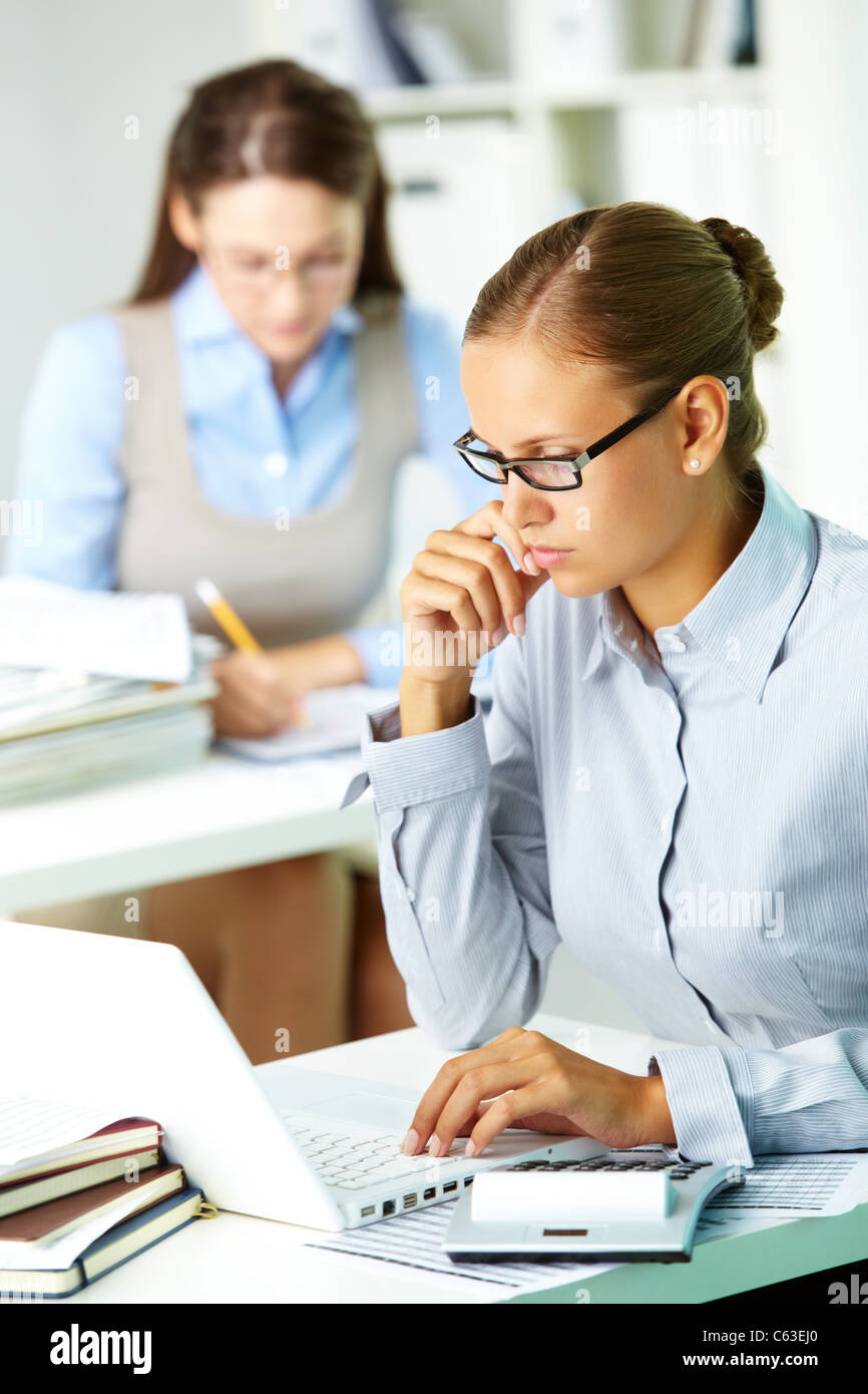 Portrait of pretty secretary working with laptop in office Stock Photo ...