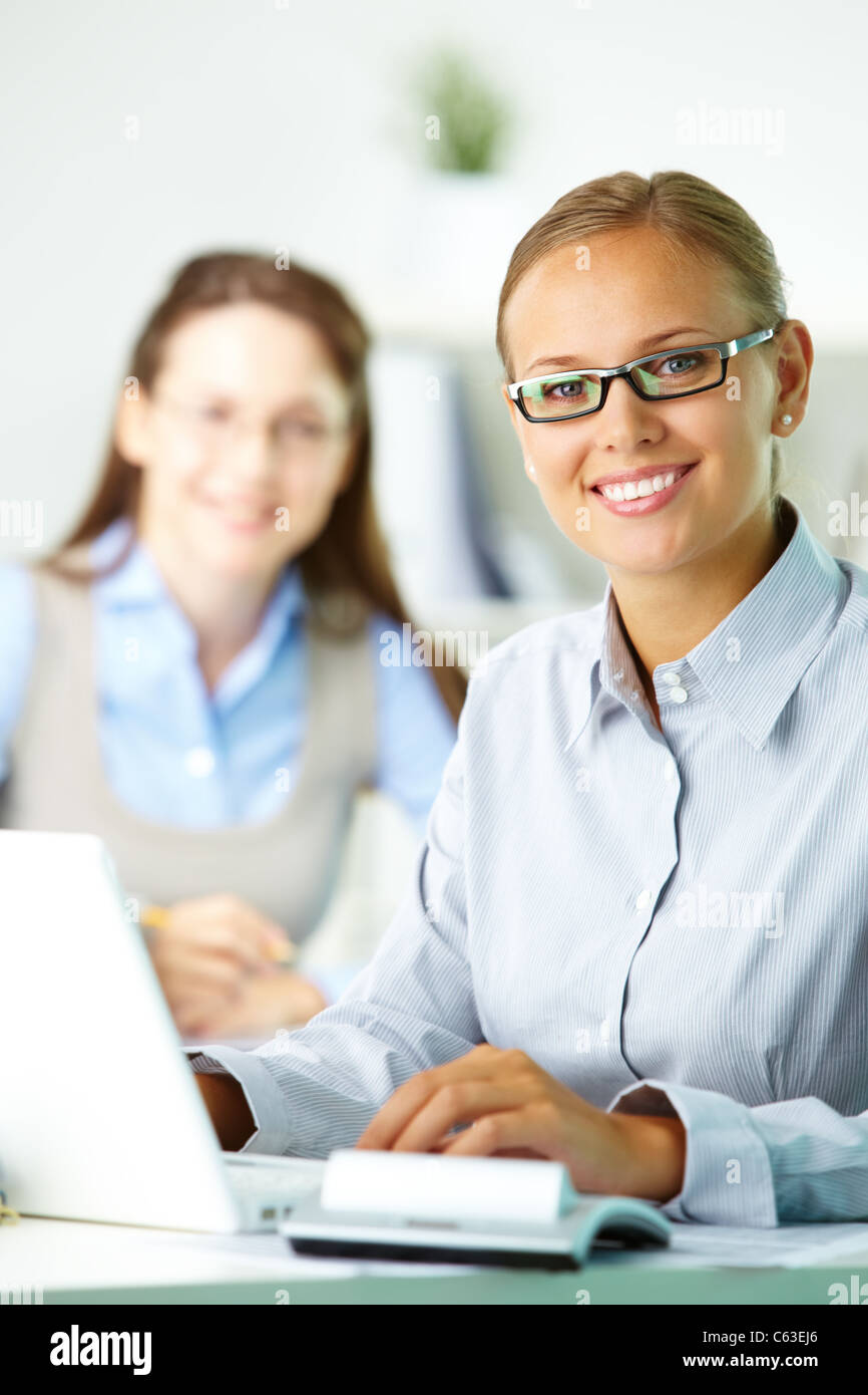 Portrait of pretty secretary looking at camera while working Stock ...