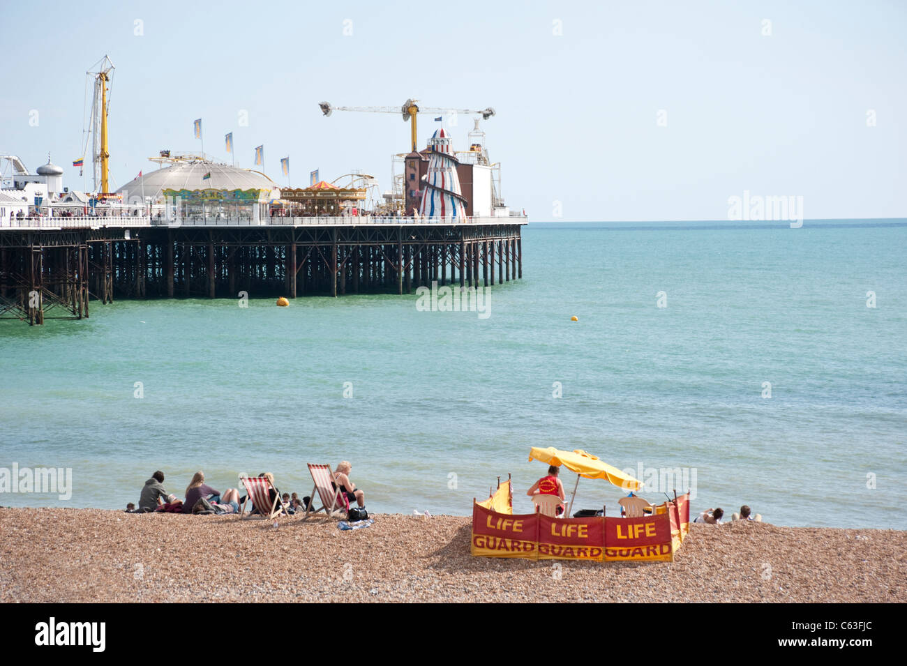 Brighton sea front with beach and fun fair on pier Stock Photo - Alamy