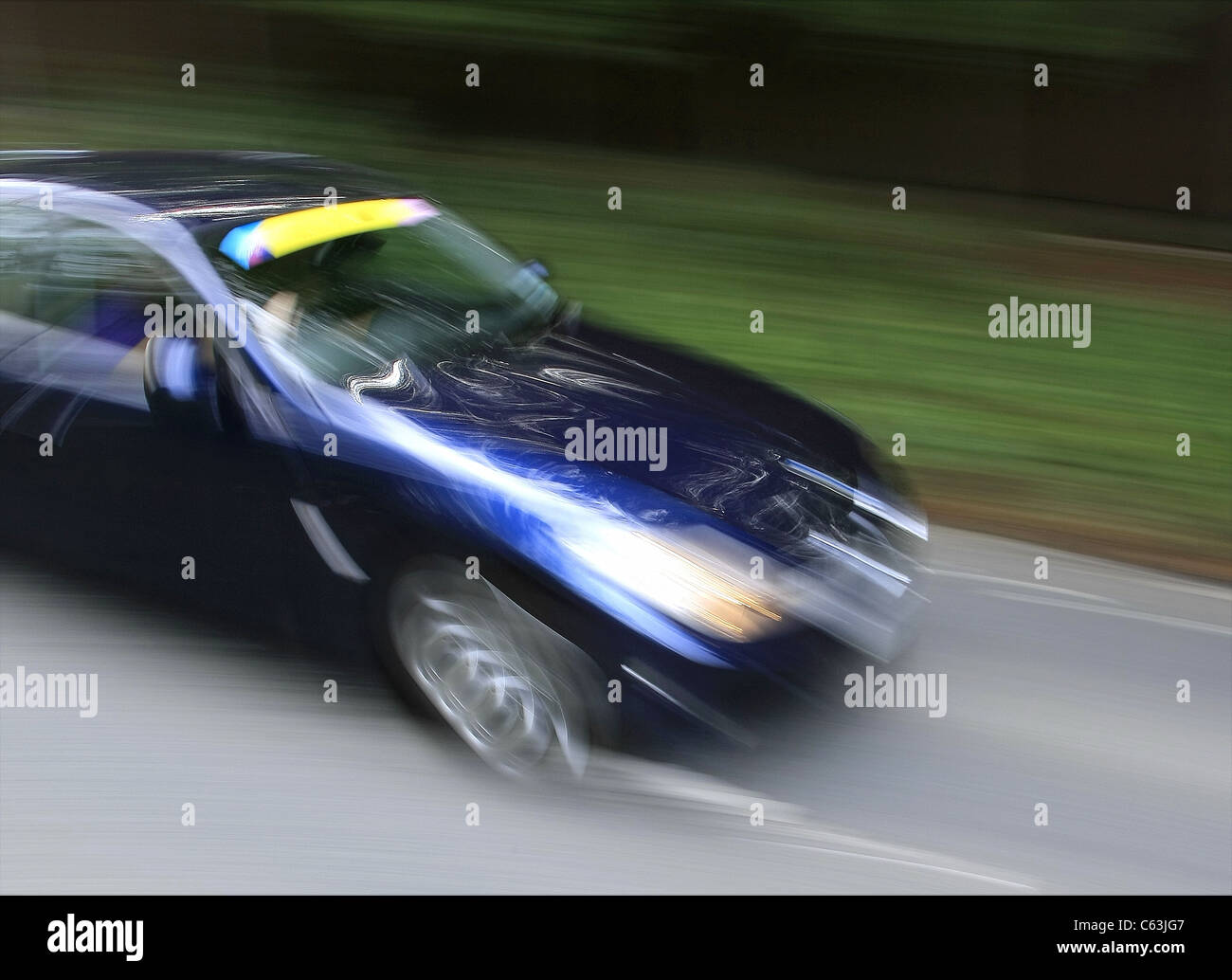 Speeding car in a blur of movement Stock Photo - Alamy