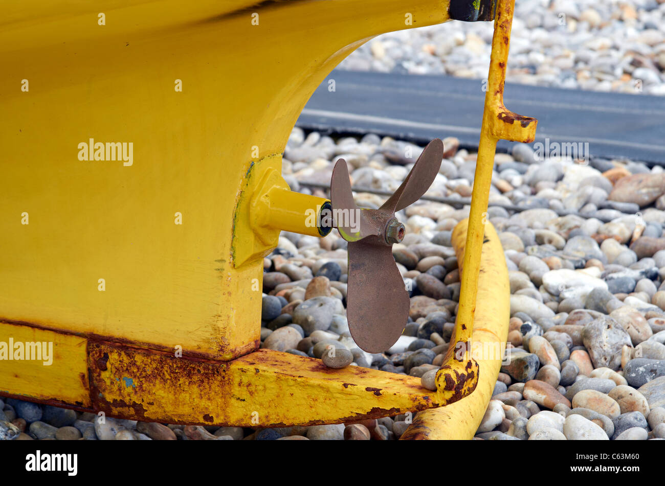 Yellow fishing boat showing the propeller and part of the rudder Stock ...