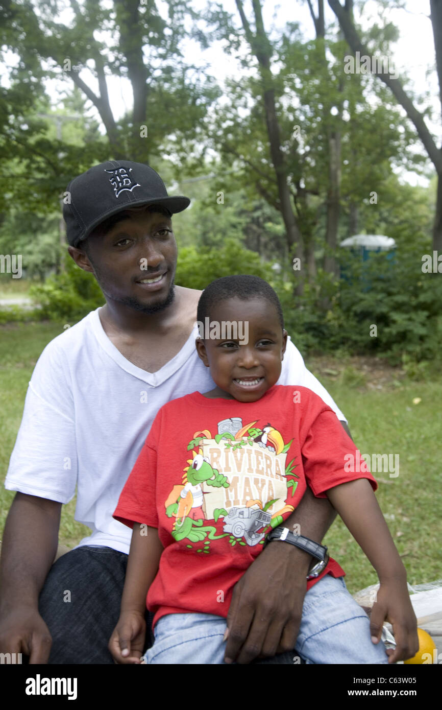 Portrait of a young man with child who works with a childcare center in ...