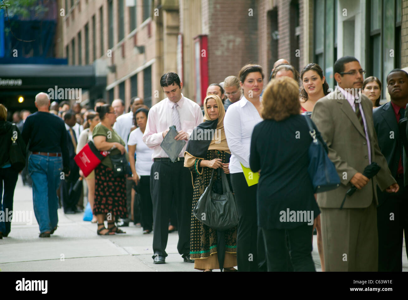 Job seekers line up for a job fair in midtown in New York on Monday ...