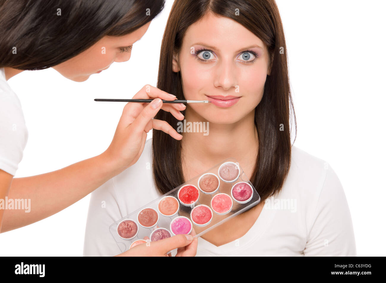 Make-up artist woman fashion model apply lipstick from color palette ...