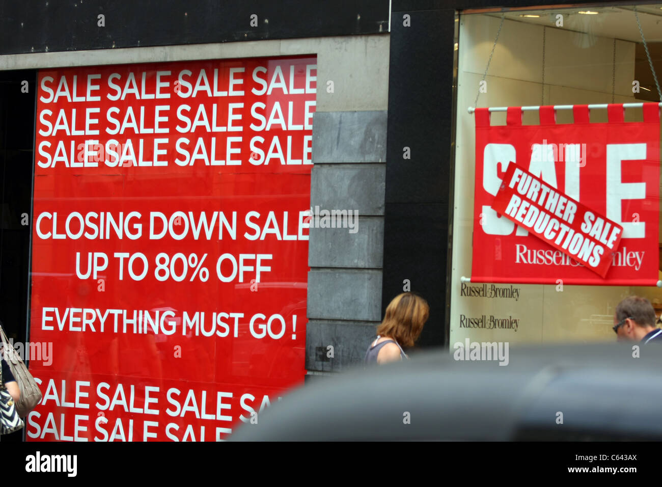 a sale sign in a shop window showing closing down Stock Photo - Alamy