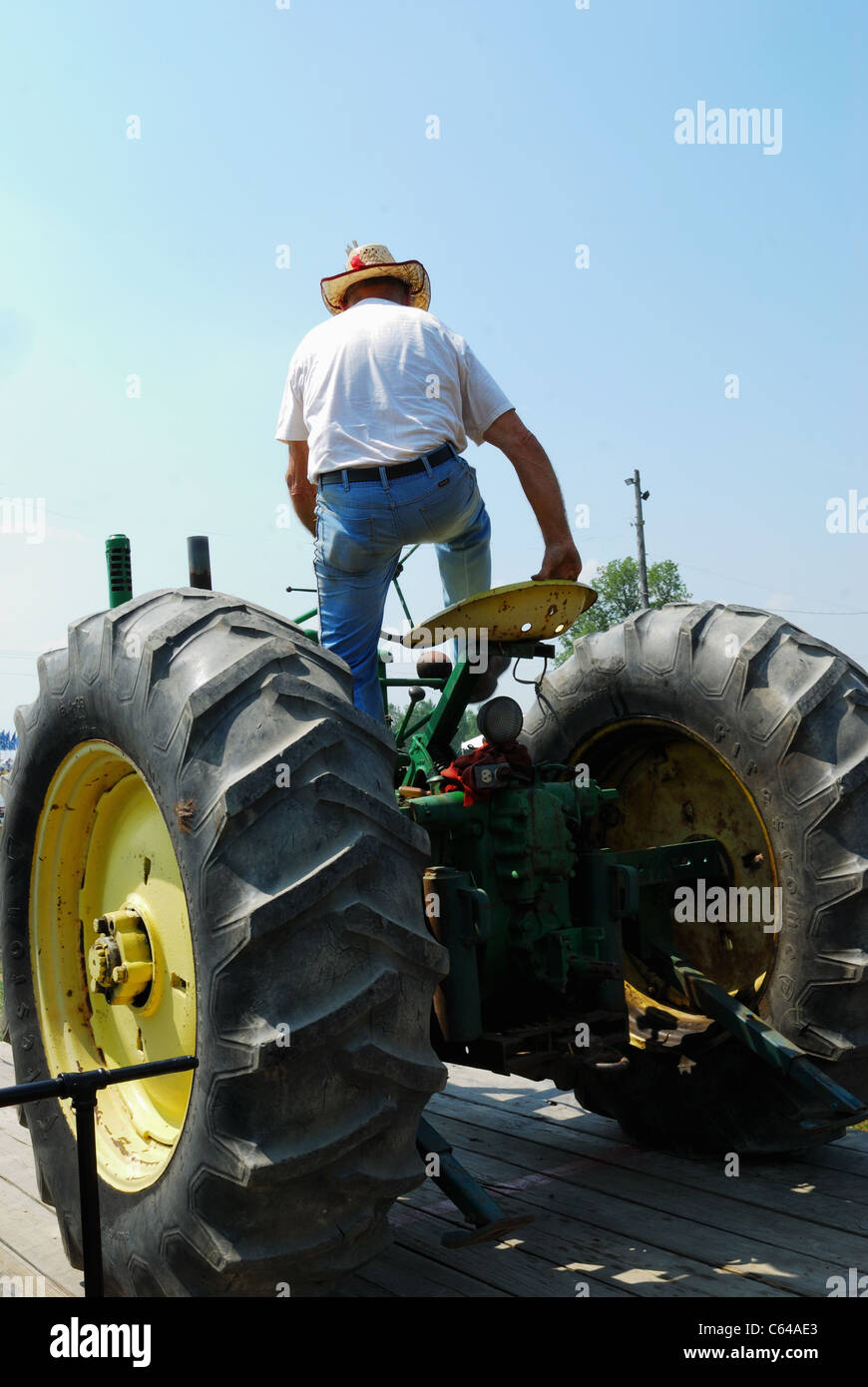 Older tractor with senior farmer in tractor pull competition Stock ...