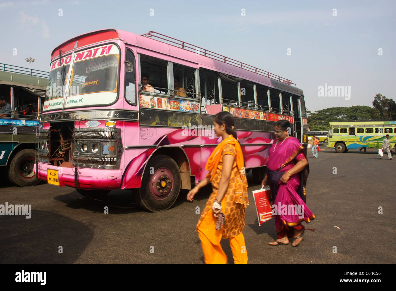 Women passengers board private Express bus departing from bus station ...