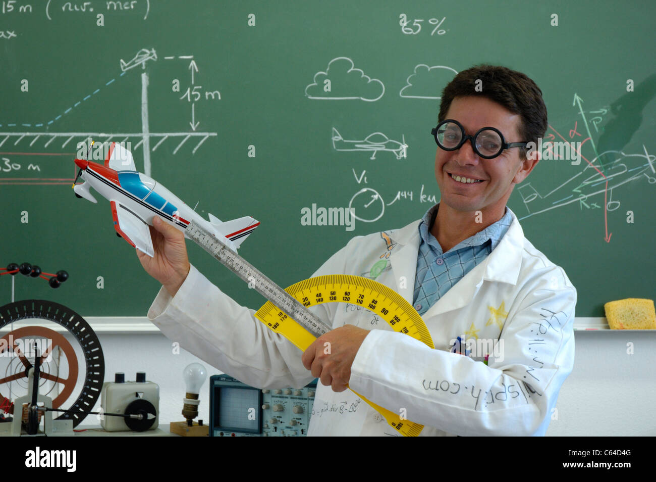 Funny school teacher explaining motorized flight with model plane Stock ...