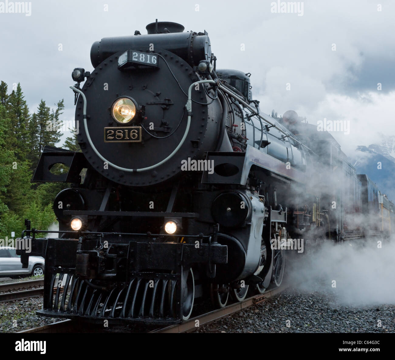 A steam engine at the station, letting off steam Stock Photo - Alamy