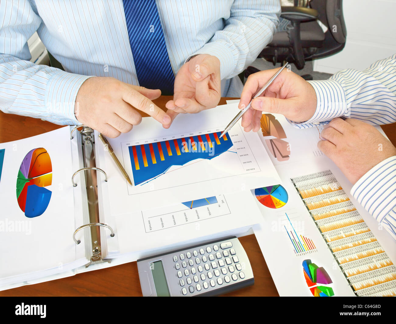 Closeup of hands with financial charts at business meeting in the ...