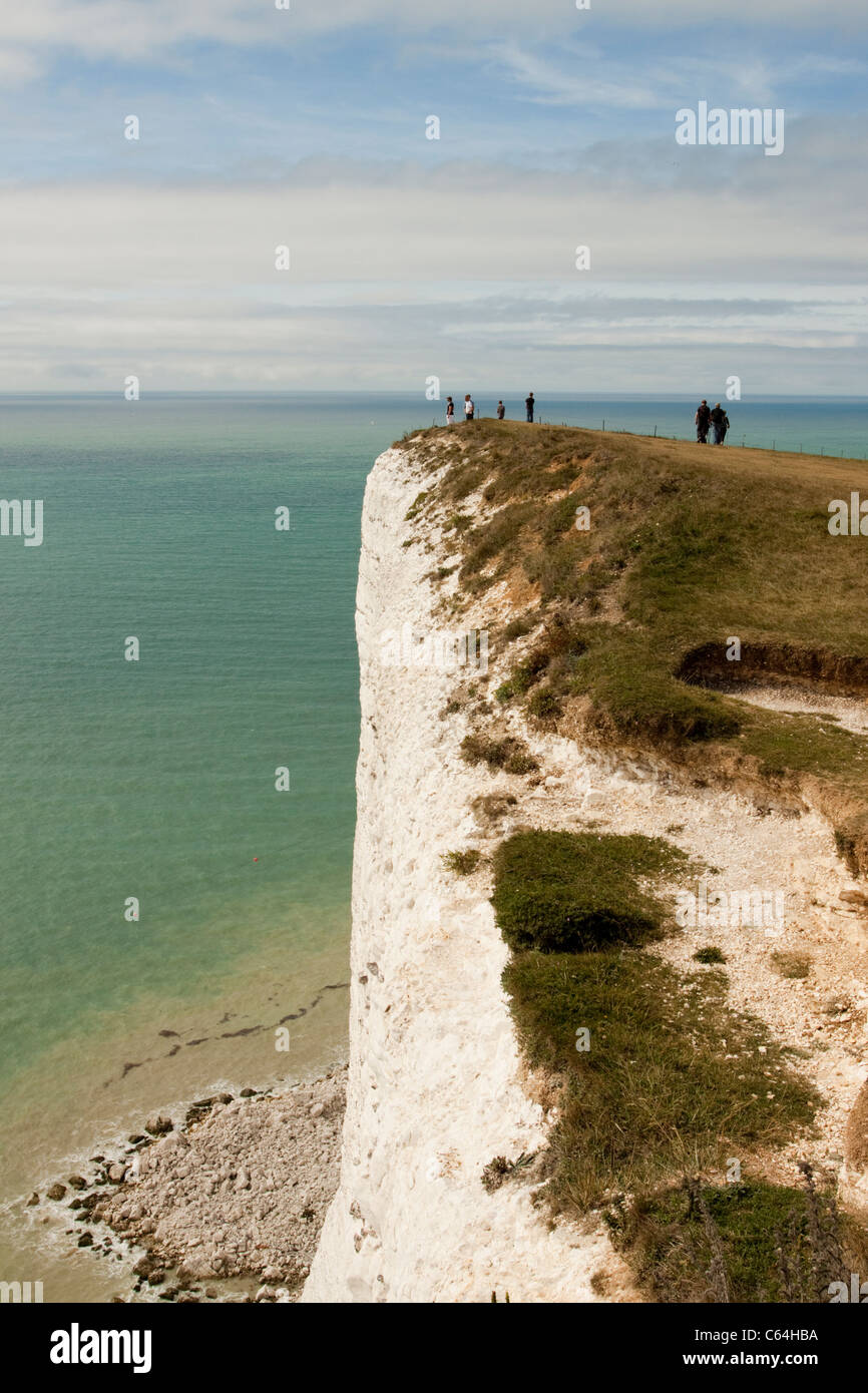 A group of people admiring the view over Beachy Head Cliffs, East ...