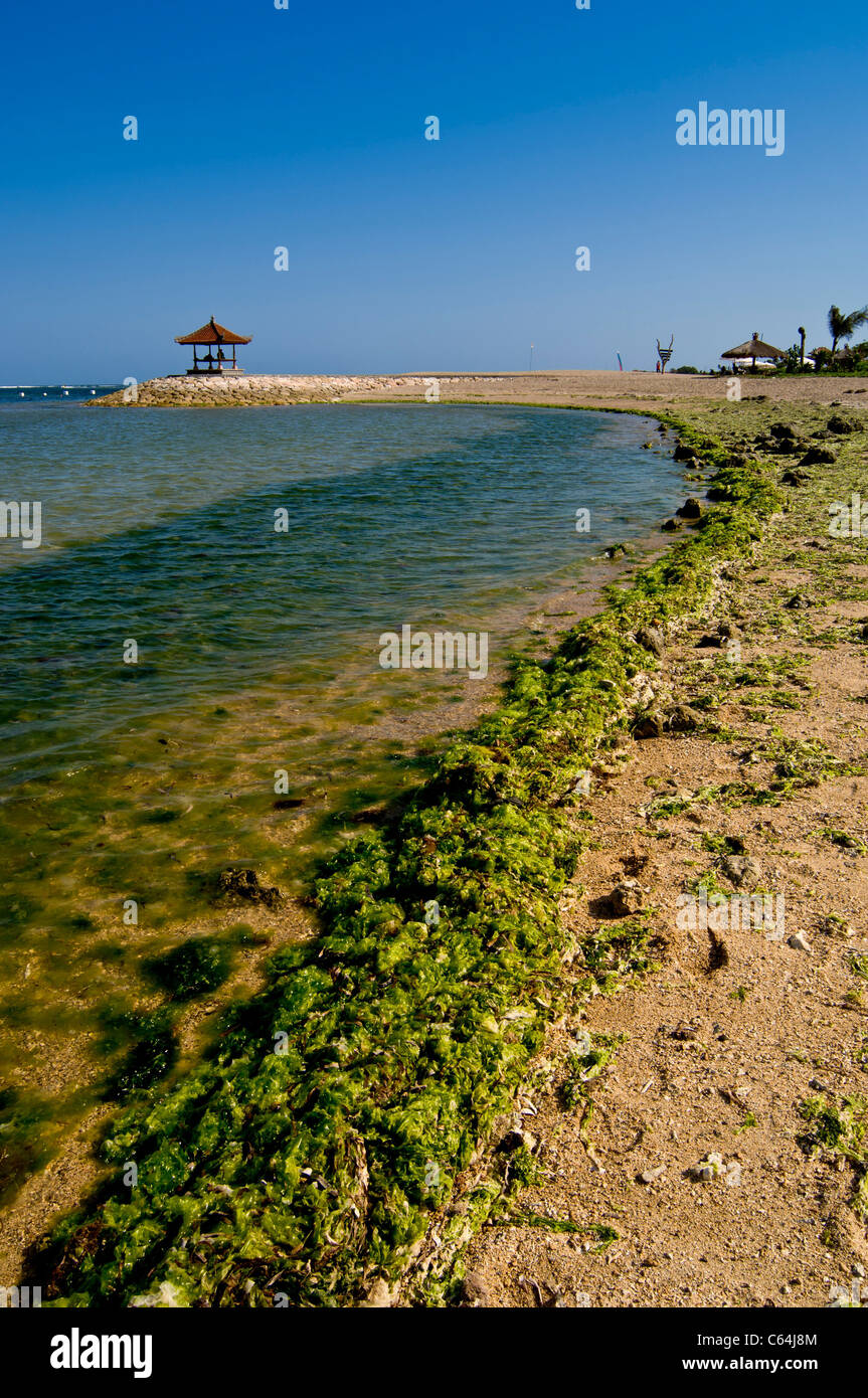 Balinese bale hut on Nusa Dua Beach, Bali. Seen against a blue sky on a ...