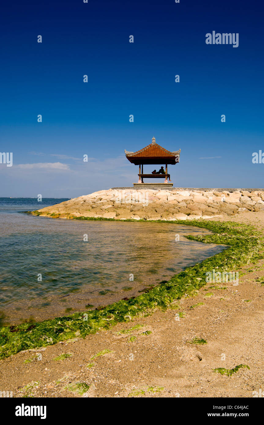 Balinese bale hut on Nusa Dua Beach, Bali. Seen against a blue sky on a ...