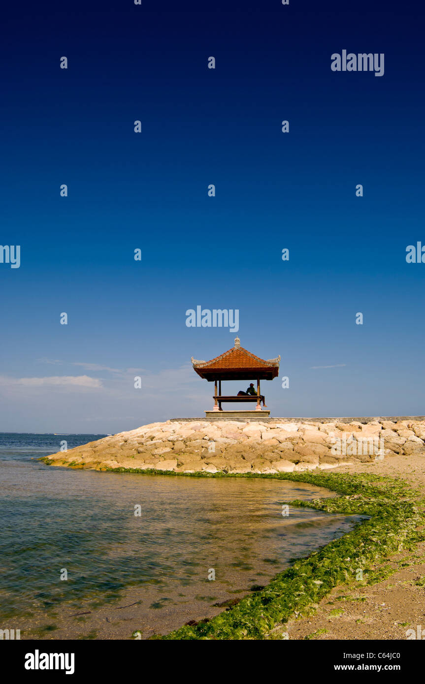 Balinese bale hut on Nusa Dua Beach, Bali. Seen against a blue sky on a ...