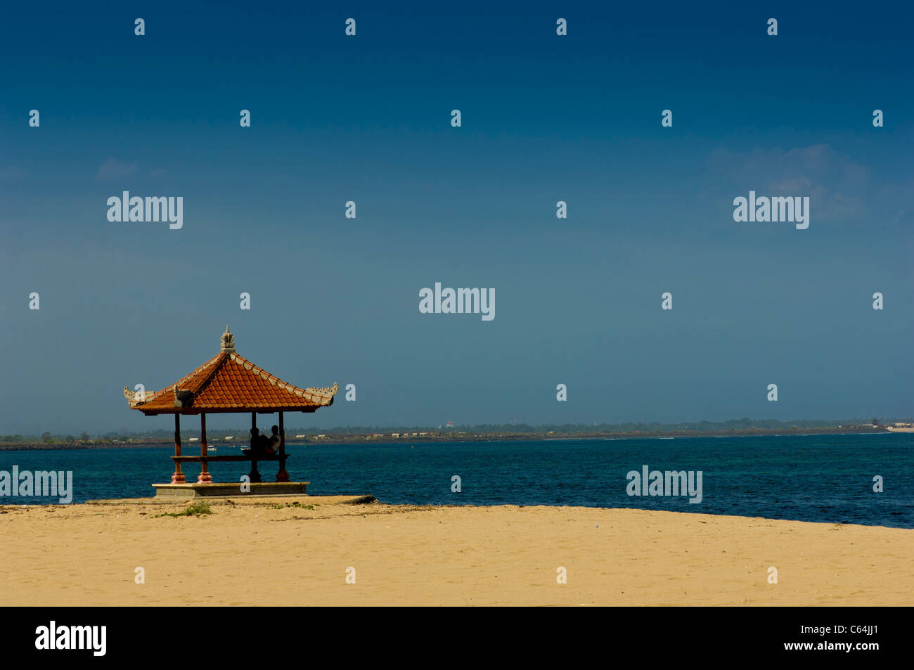 2 unidentifiable people sitting in a Balinese bale hut on Nusa Dua ...