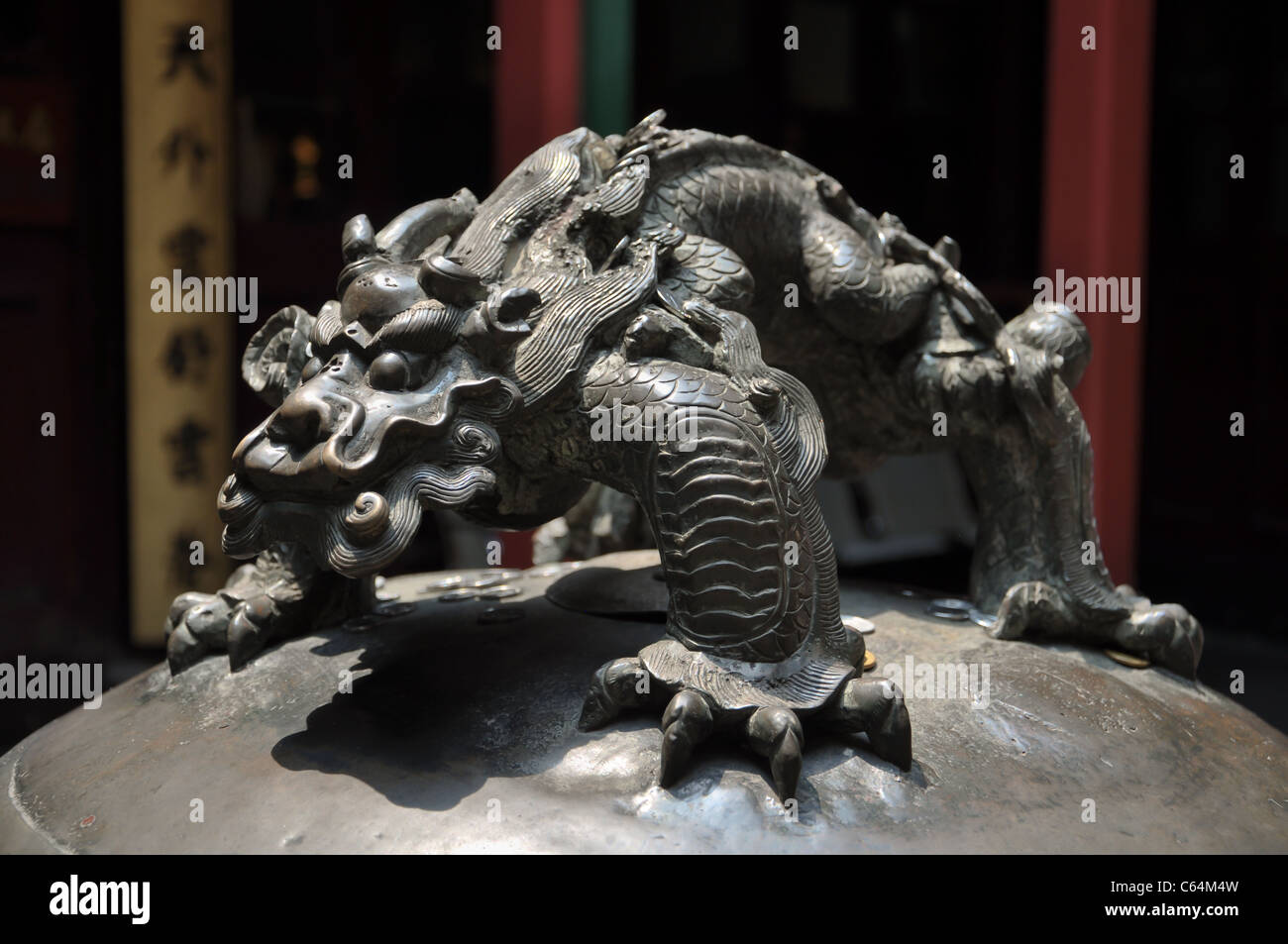 detailed close up of a chinese fable animal atop an ornamental bronze ...
