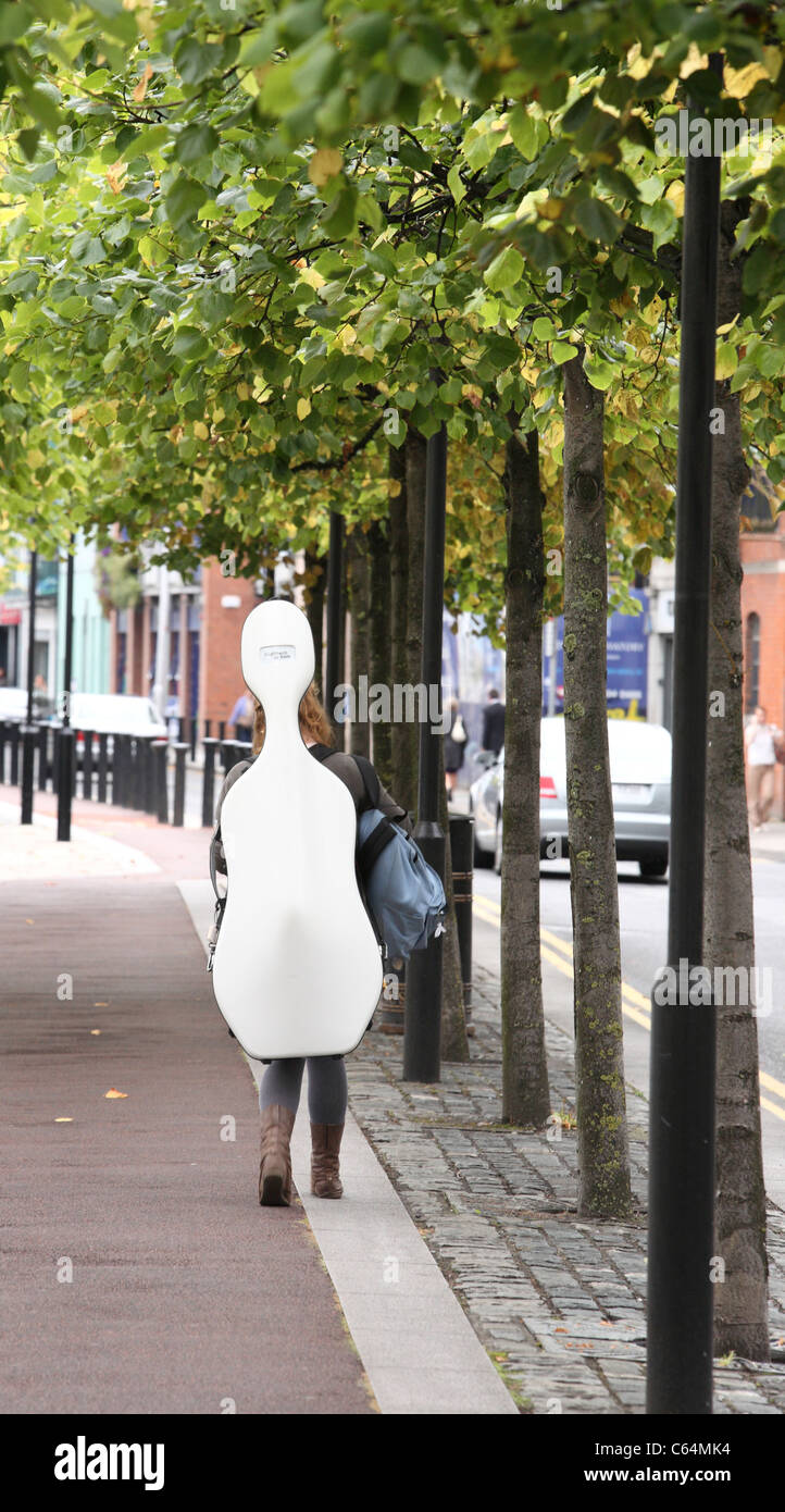 Cello case walking Stock Photo - Alamy