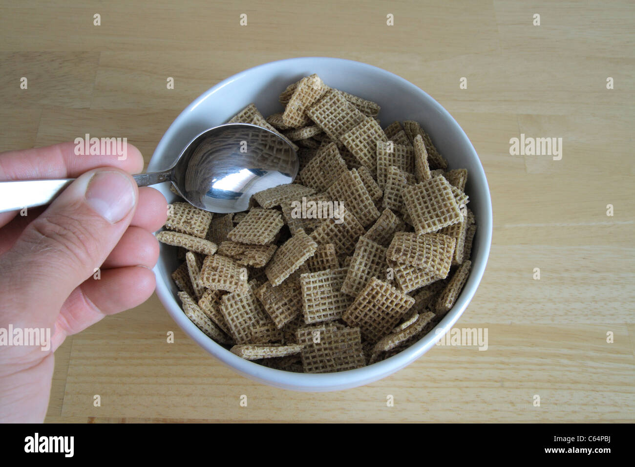 Caucasian Adult Male using a spoon to eat Shreddies Breakfast Cereal ...