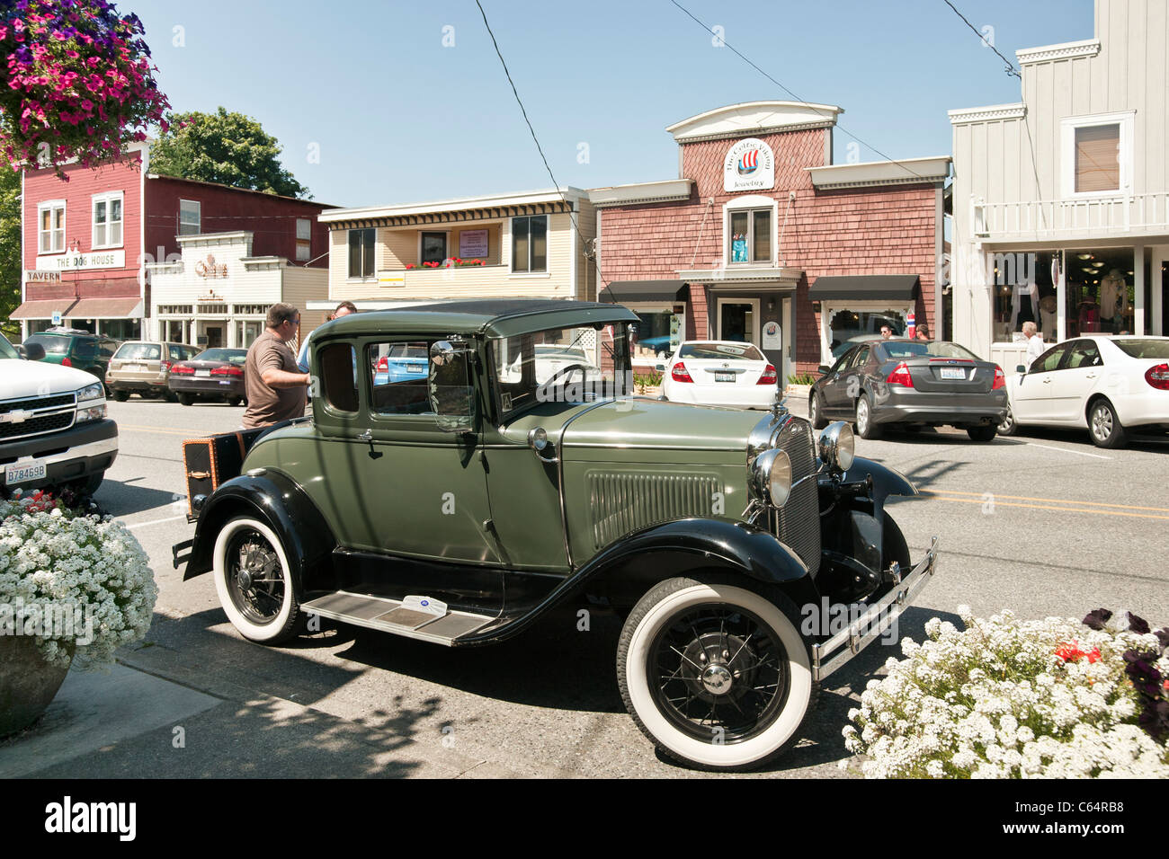 superb restored Model A Ford parked on main street against backdrop of ...