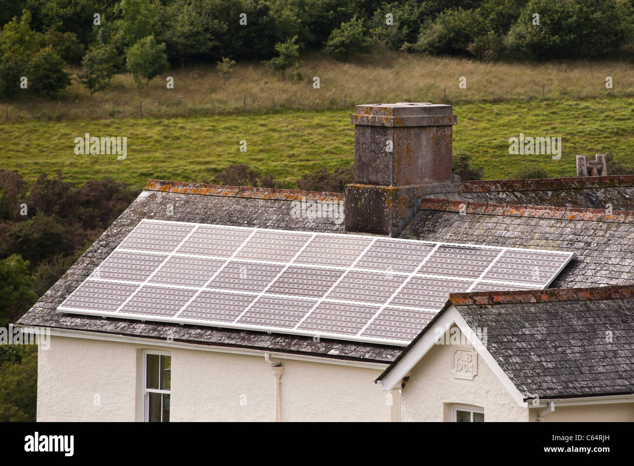 Photovoltaic solar power panels mounted on the roof of a farmhouse in a ...