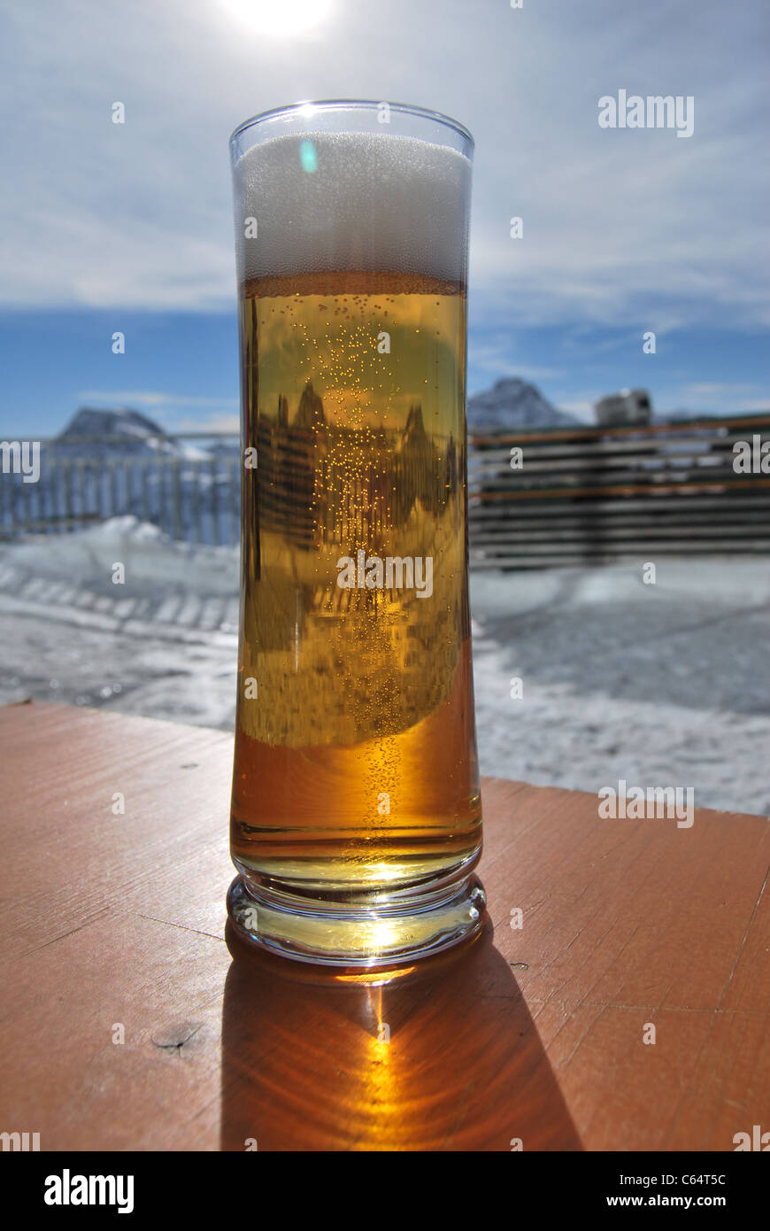 looking at the mountains through a pint of beer Stock Photo - Alamy