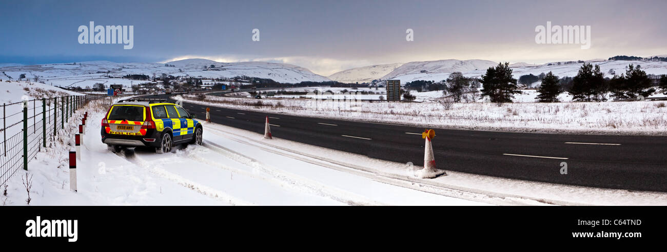 Panoramic sweeping view of Police Patrol on Motorway in Winter Snow, UK ...
