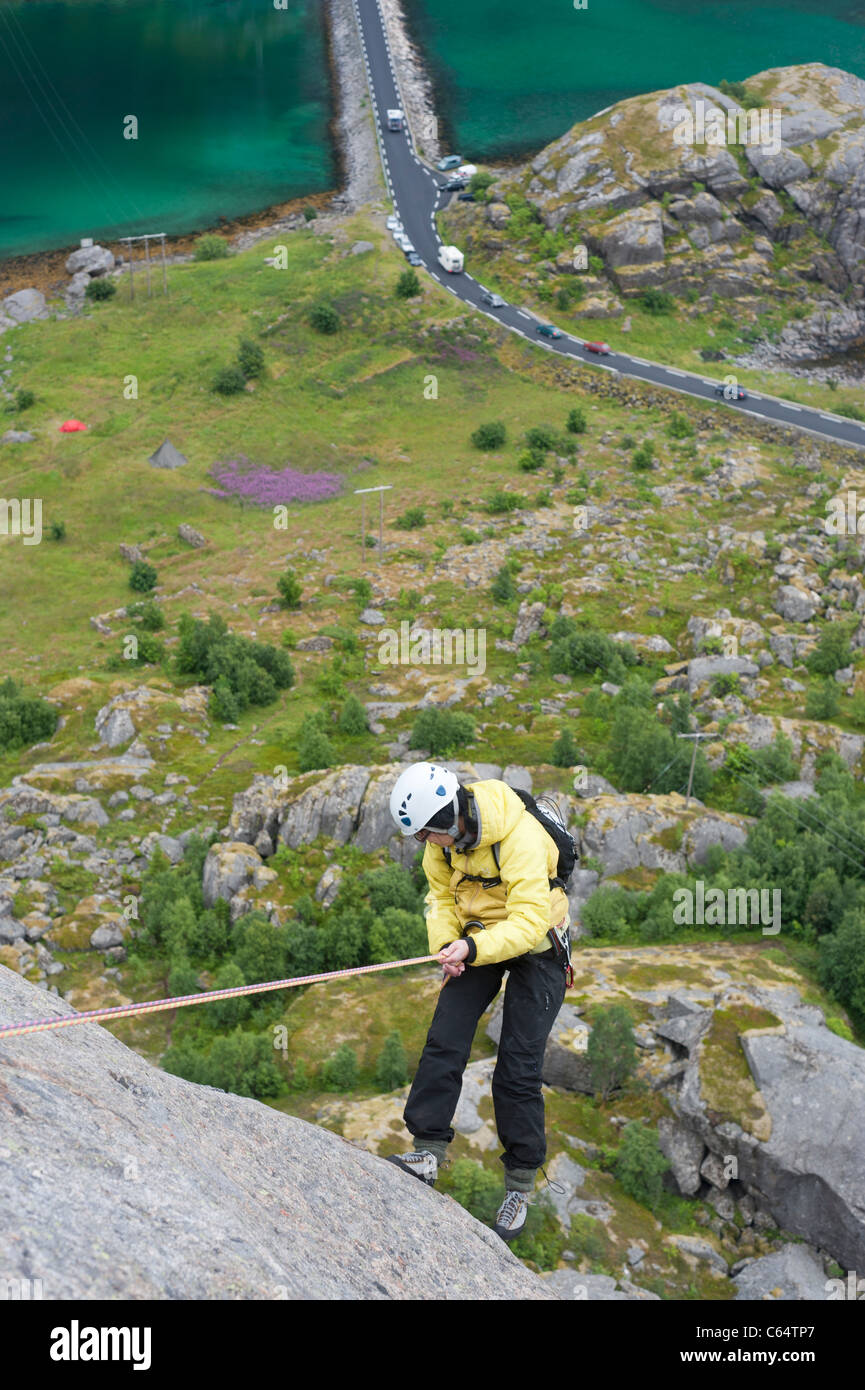 A female rock climber abseiling on Lofoten Islands, Norway Stock Photo ...