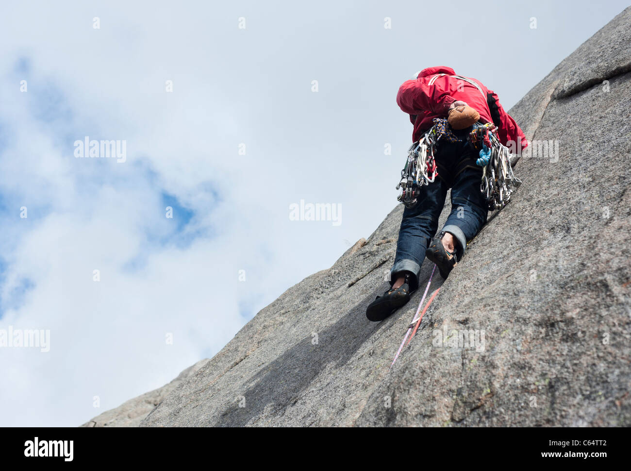 A male rock climber climbing in traditional style in Lofoten Islands ...