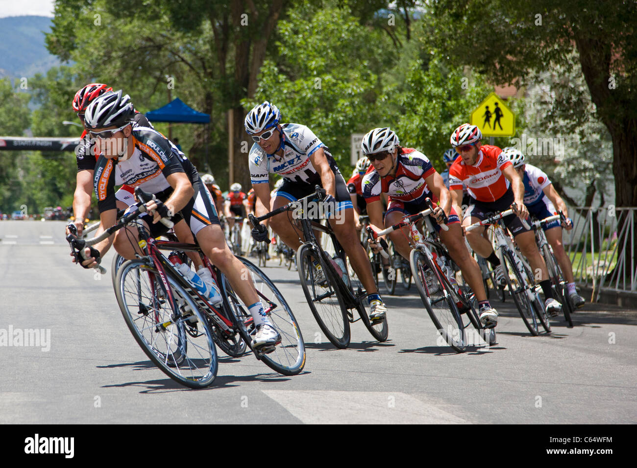 Professional cyclists race in the criterium event through small town of ...