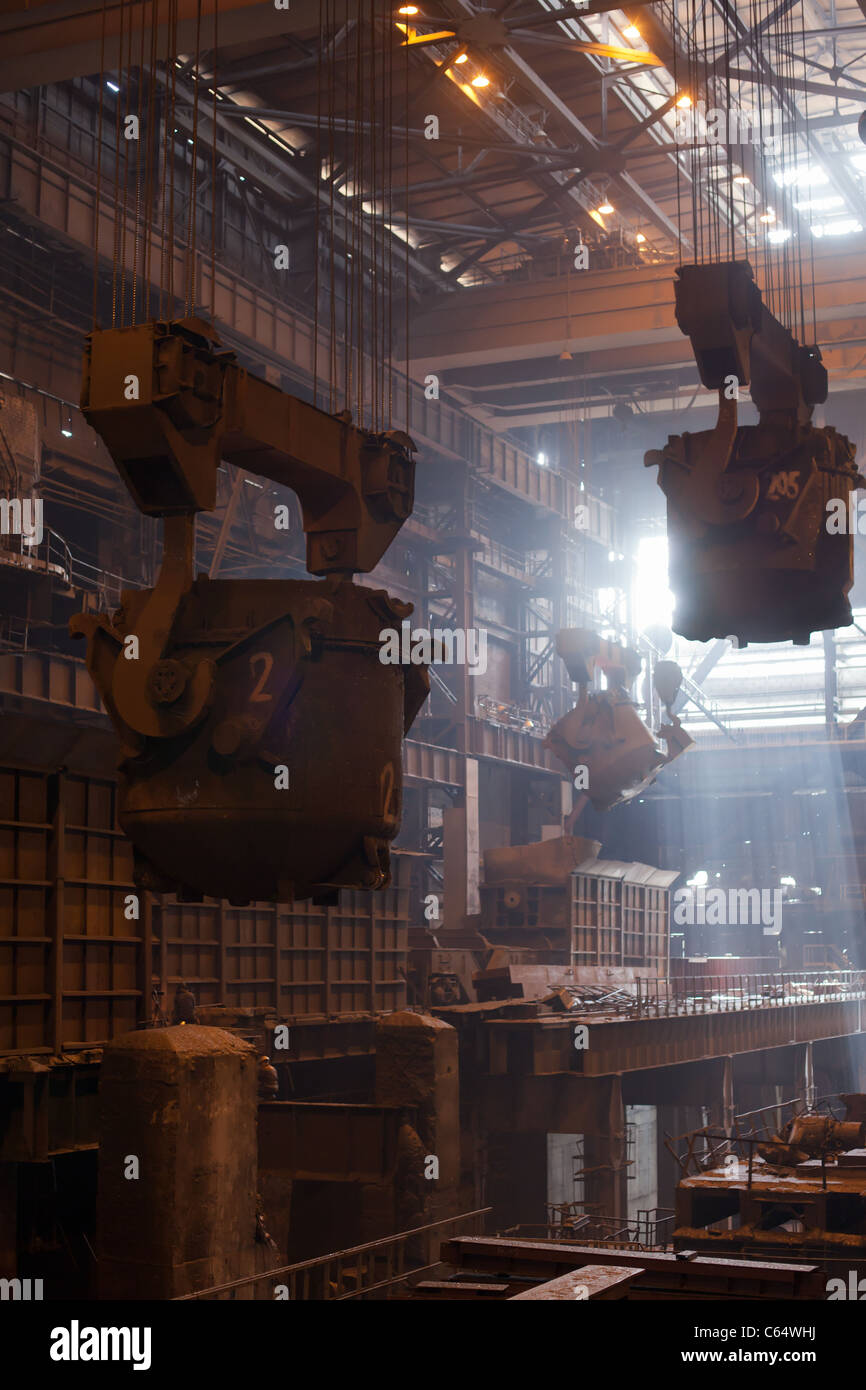 Smelting metal in a metallurgical plant. Liquid iron from the ladle ...