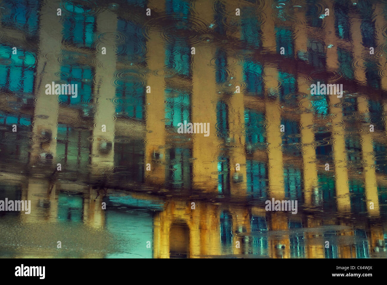 Reflection of urban building in a puddle of rain with the drops Stock ...