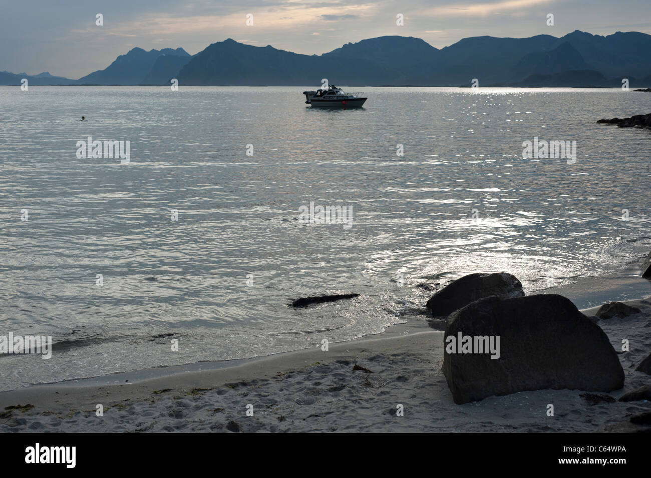 Beach and swimmers during at sunset near Svolvaer, Lofoten Islands ...