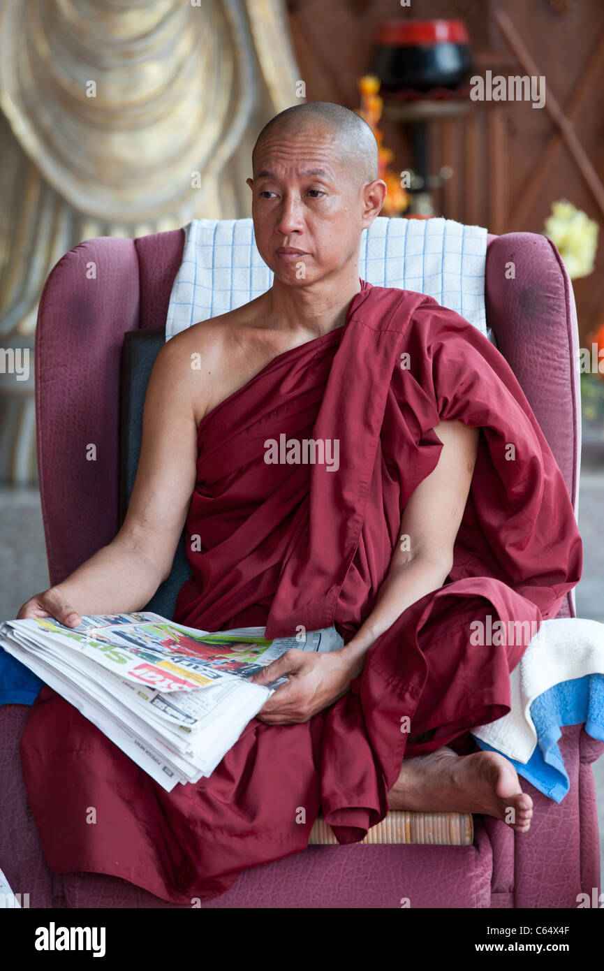 Buddhist Monk Reading the Newspaper in Dhammikarama Burmese Temple ...