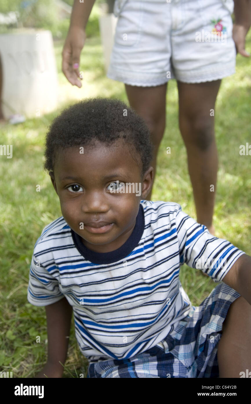 Portraits of African American children in the poverty stricken, rundown ...