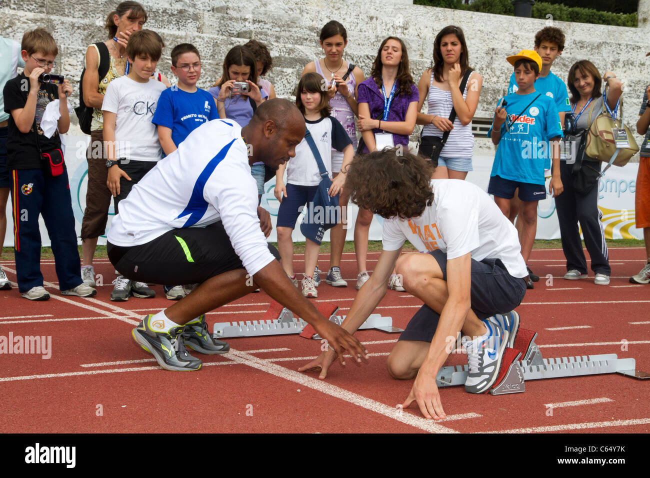 Asafa Powell athlete sprinter 100m teaching to a group of young ...