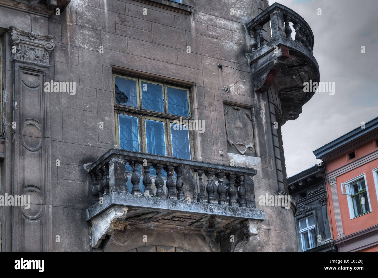 Balcony with a broken window of an old city building Stock Photo - Alamy