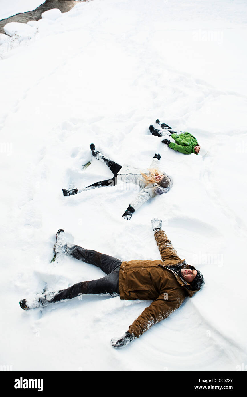 Family making snow angels Stock Photo - Alamy