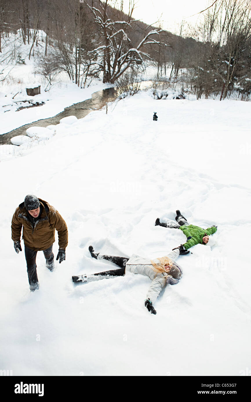 Family making snow angels Stock Photo - Alamy
