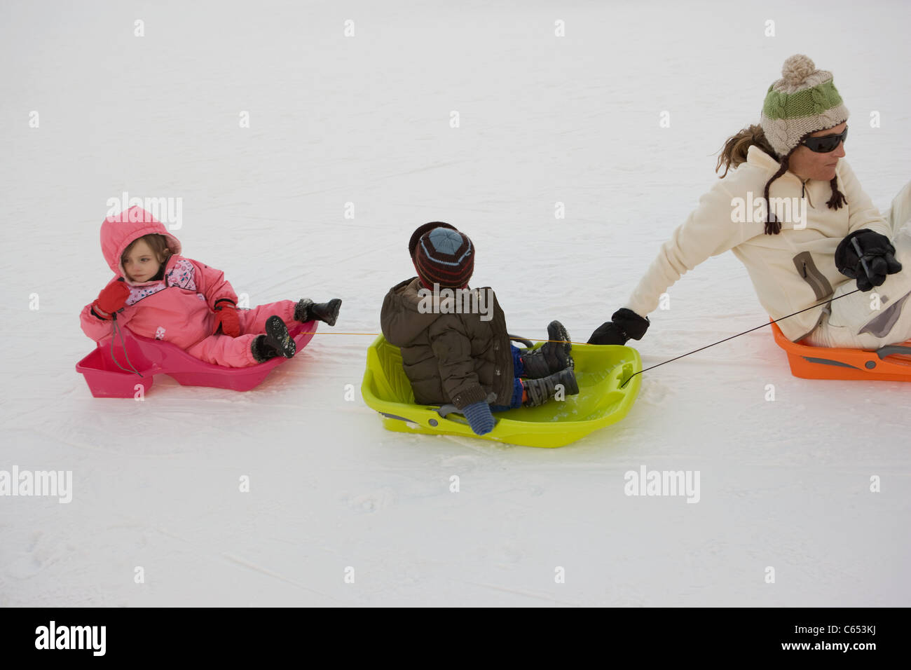Two children pulling sledges hi-res stock photography and images - Alamy