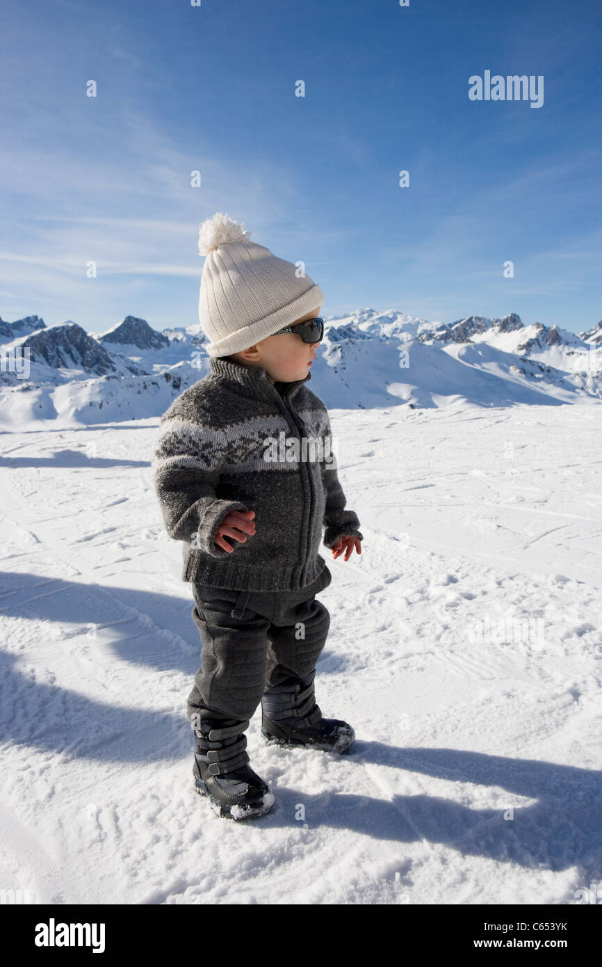 Portrait of boy standing in snow Stock Photo - Alamy