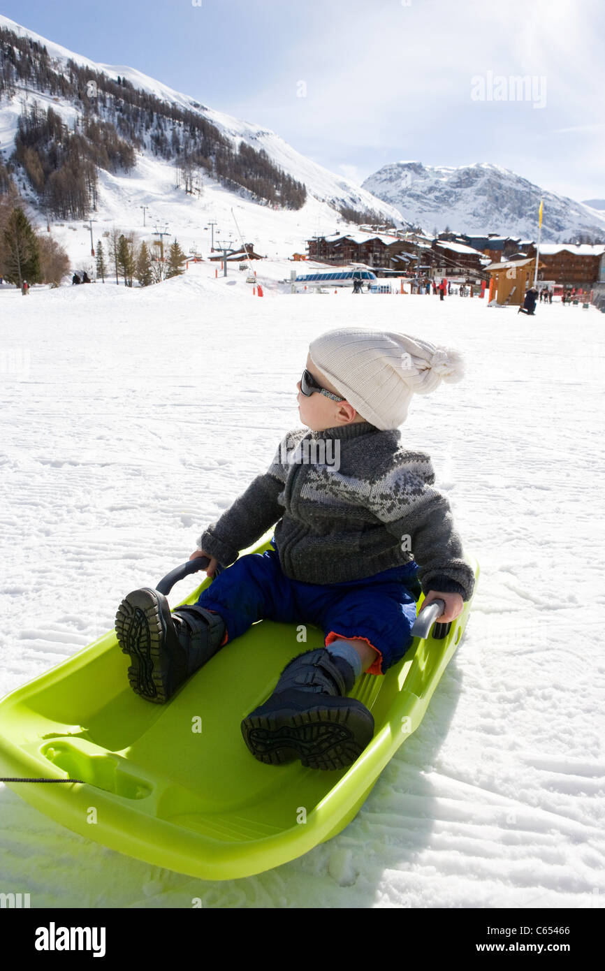Boy sitting on sledge Stock Photo - Alamy