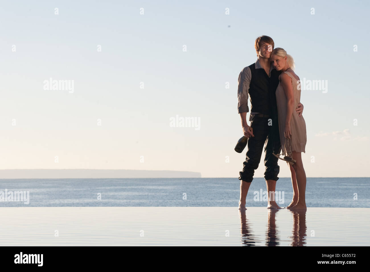 Couple by the ocean Stock Photo - Alamy